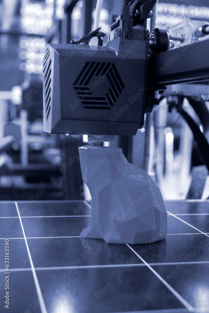 3D printer printing prototype of toy from molten plastic. Process of ...