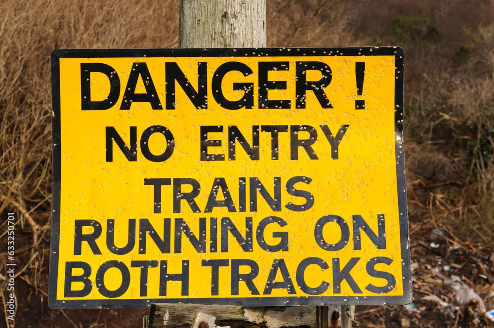 Railway sign saying "Danger! No Entry. Trains running on both tracks ...