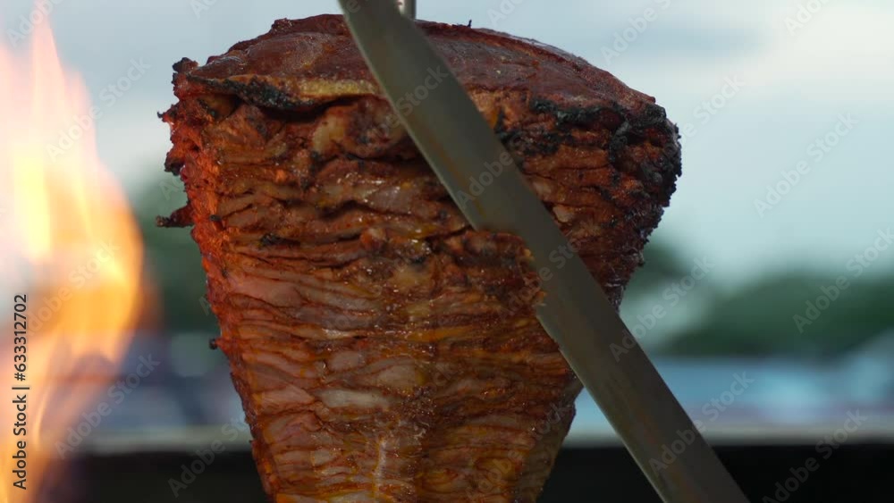 Mexican latin taquero spinning the trompo of Carne al pastor asada beef ...