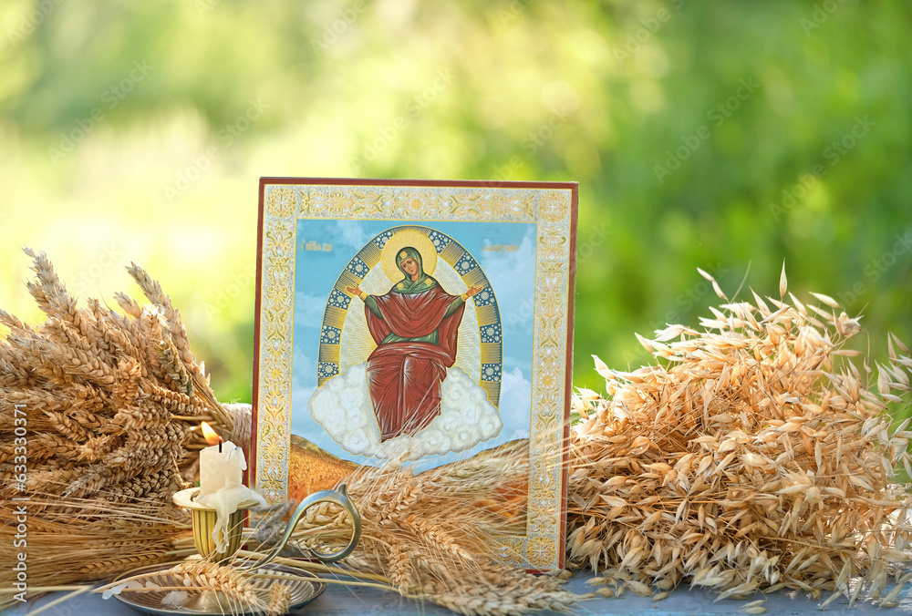 old orthodox icon with Our Lady image, candlestick and ripe grain ears ...