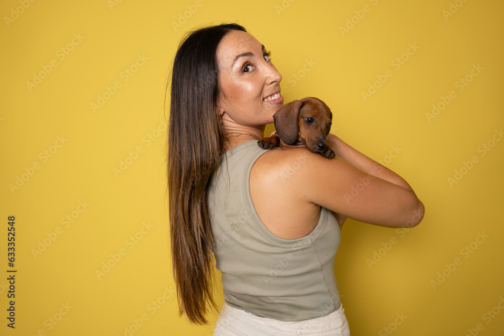 Back view Cute young woman hugs her puppy schnauzer dog. Love between ...