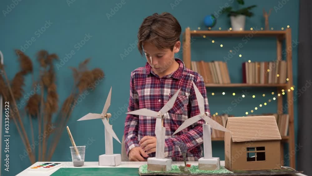 Creative child creating renewable energy and eco housing projects at ...