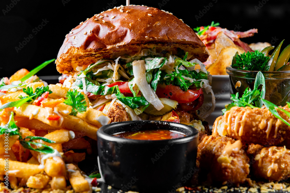 fast food set on plate. burger, potato chips, french fries, chicken ...