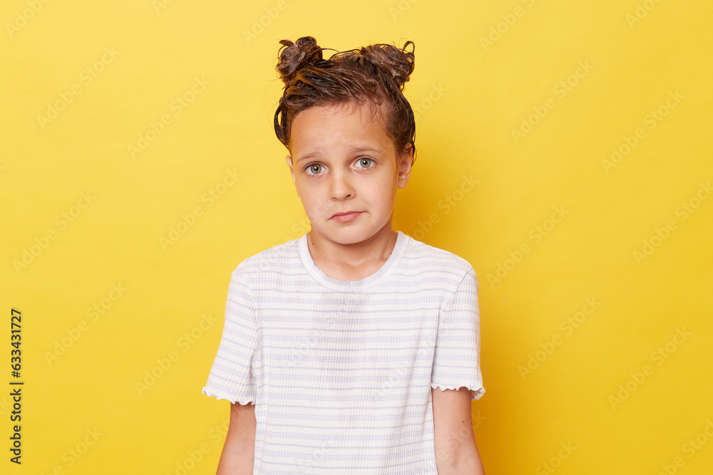Uncertain child girl with shampoo on wet hair wearing white T-shirt ...