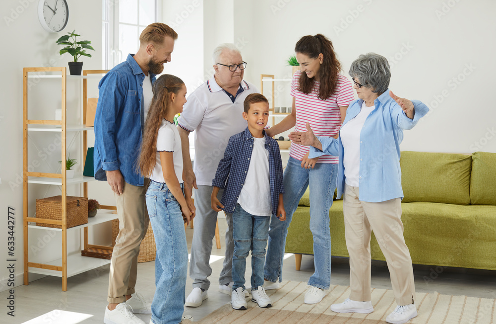 Big happy family congratulates son and grandson standing at home in ...