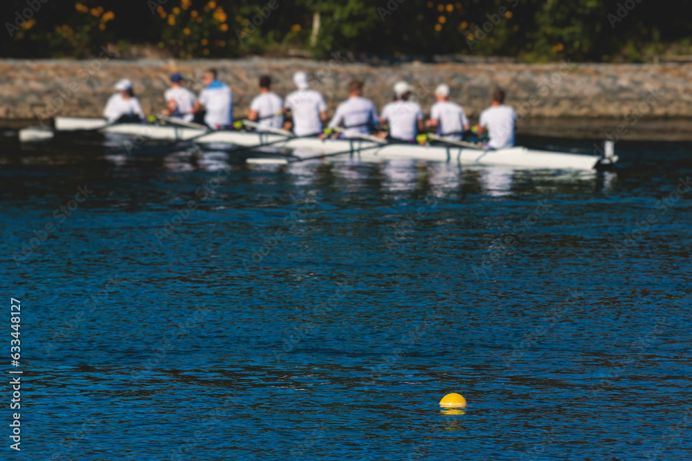 Group of rowing team athletes sculling during competition, kayak boats ...