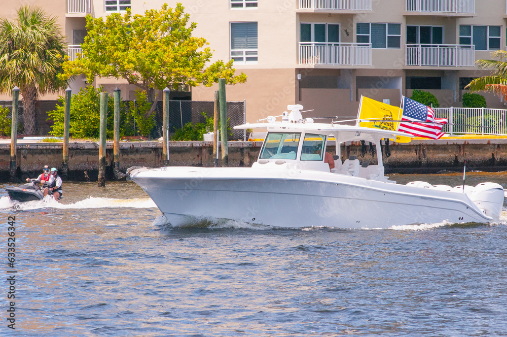 Side view, medium distance of, a white, fiberglass, speedboat, powered ...