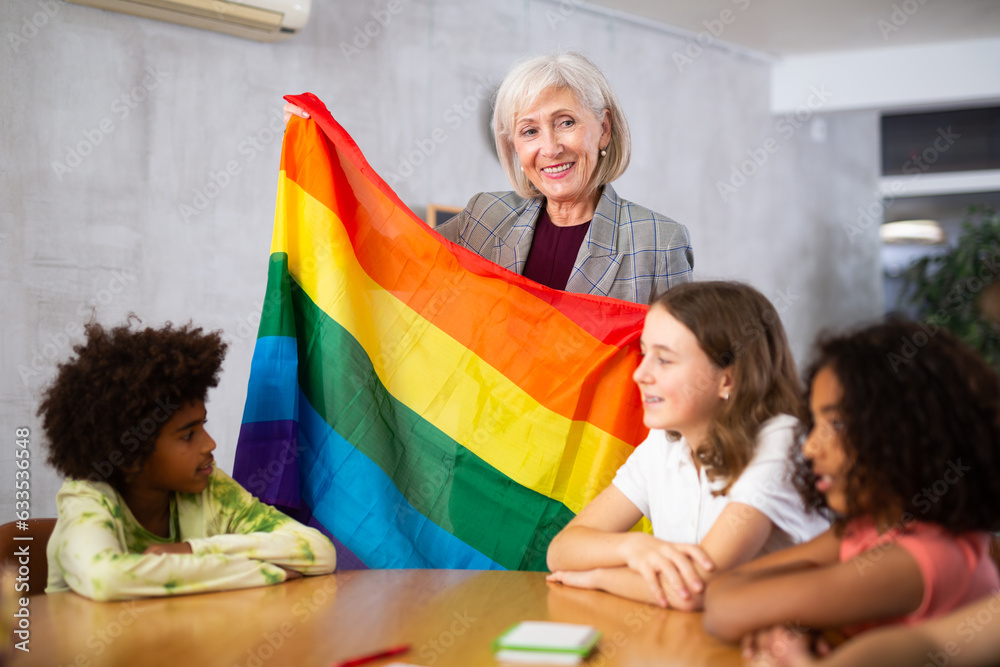in classroom, positive woman teacher introduces children to concept and ...
