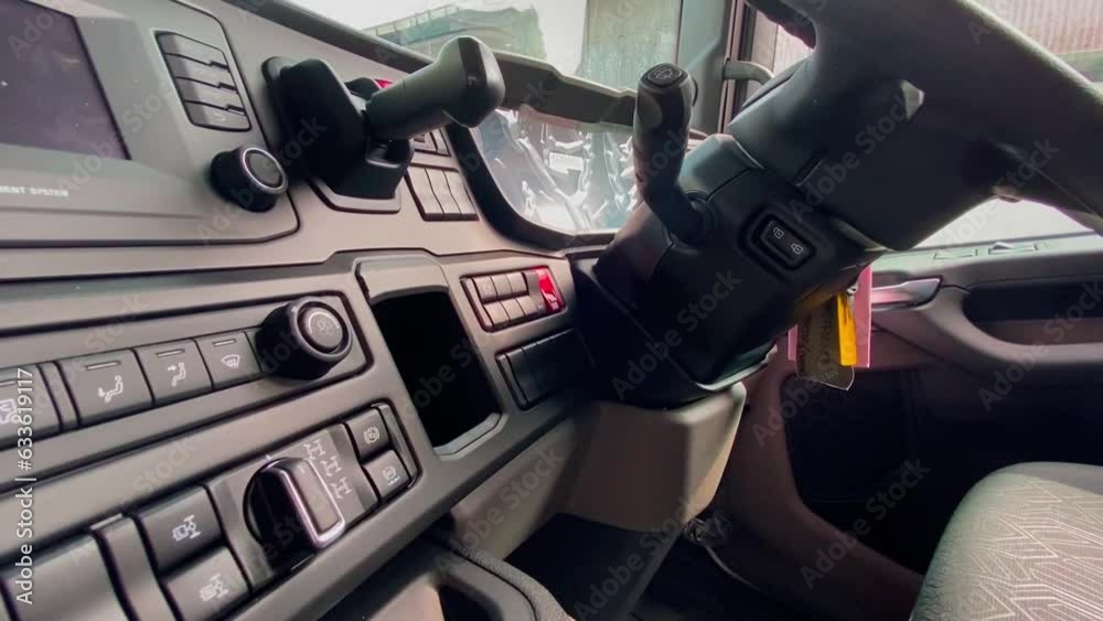 Driver's cabin of modern truck with lots of automatic buttons. Driver's ...