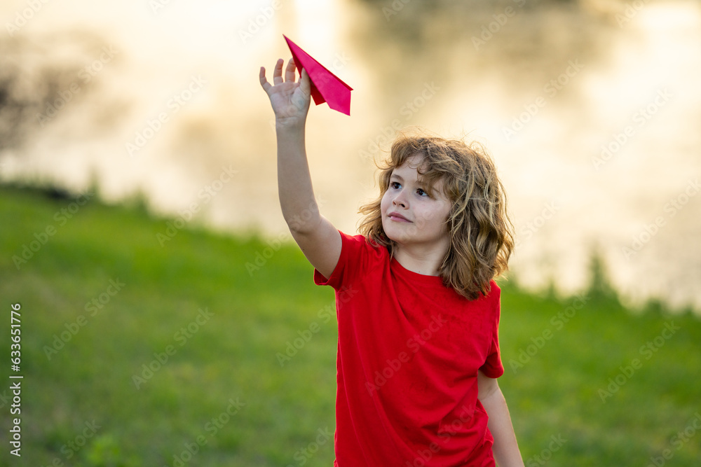 Happy kid hold paper planes. Toy airplane in children hands outdoor ...