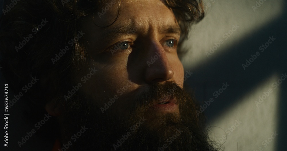 Depressed prisoner in orange uniform sits in prison cell, smokes ...