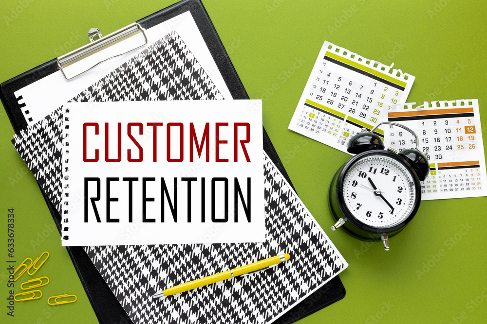 Customer Retention. green background. desk clock.calendar. text on ...