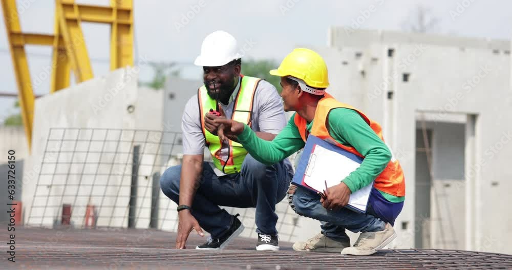 Engineer inspecting steel wire mesh for concrete slab reinforcement of ...