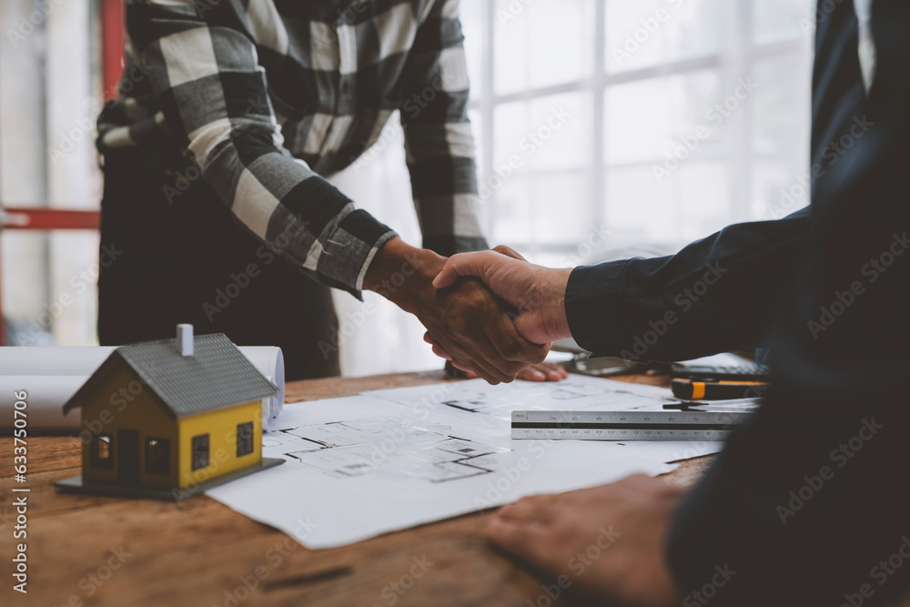 Architects and engineers working together and handshake business ...