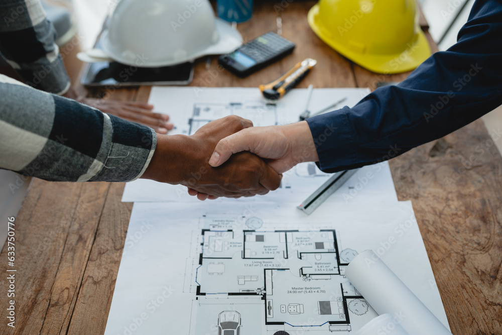 Architects and engineers working together and handshake business ...
