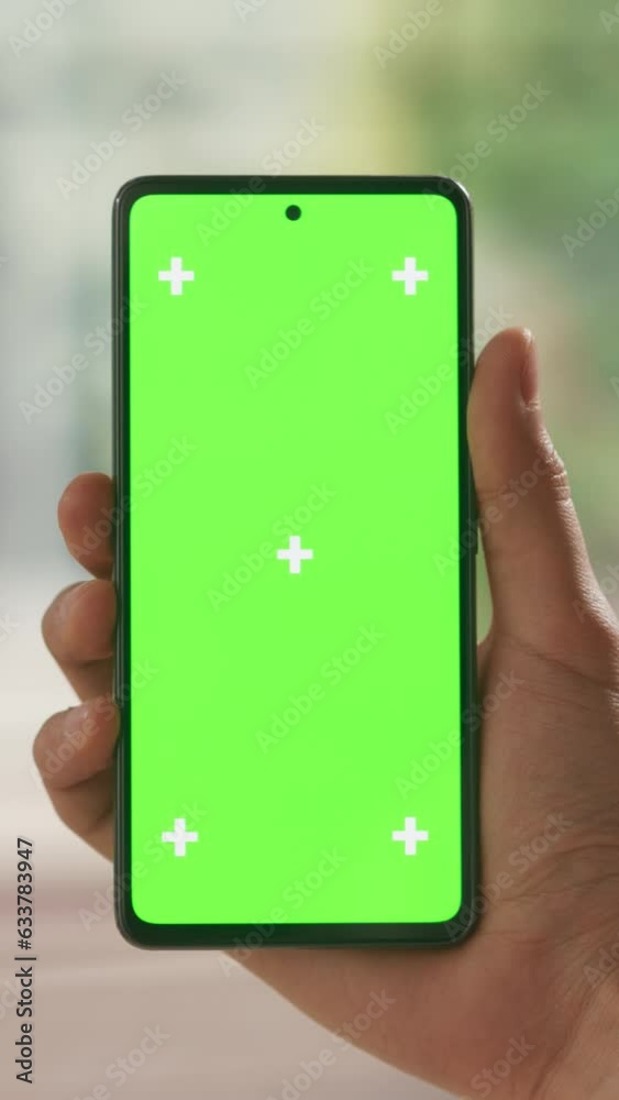 Vertical Screen: POV View of a Manager Holding a Smartphone with Green ...