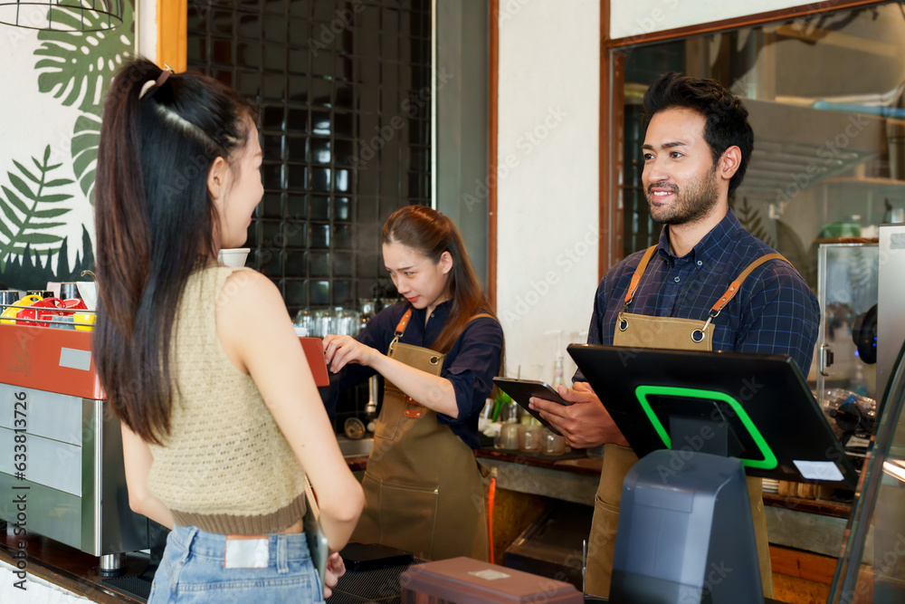 Indian man descent is taking orders from a beautiful Asian customer ...