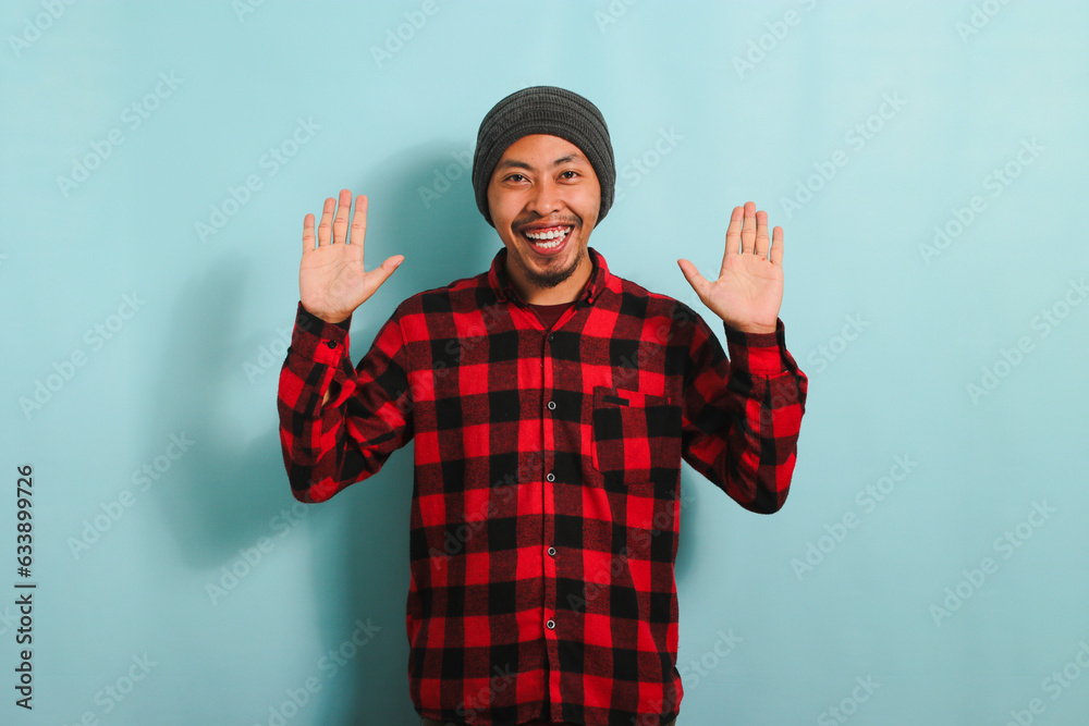 An attractive and friendly young Asian man with a beanie hat and a red ...