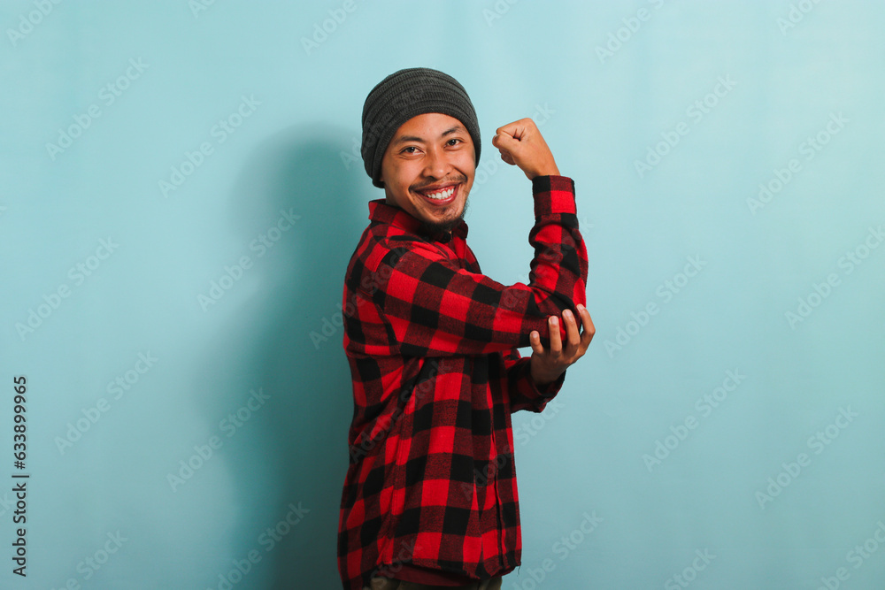 Excited Young Asian man with beanie hat and red plaid flannel shirt ...