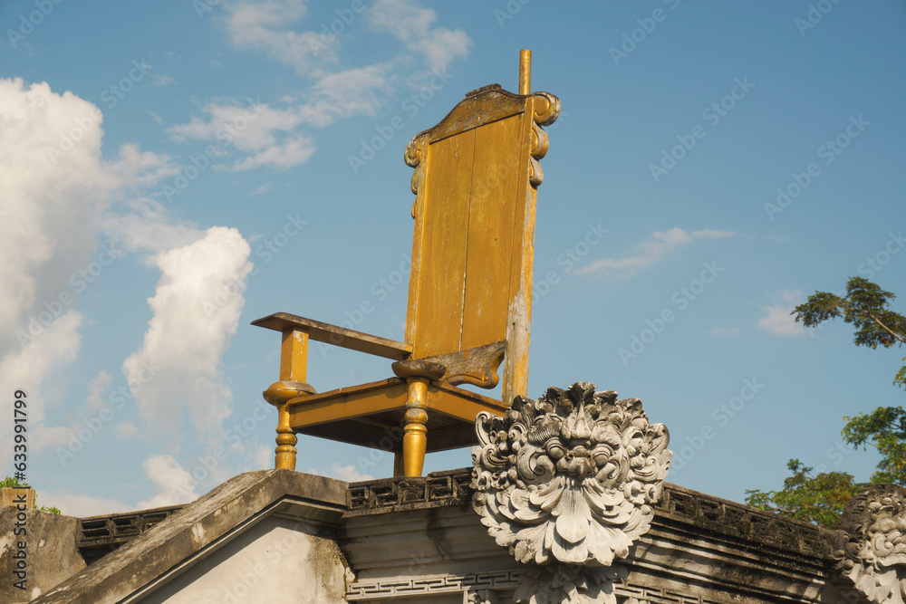 a throne chair stands in front of a collapsed palace on Kumala Island ...