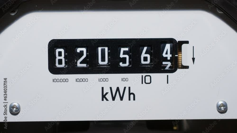 A close-up of a domestic electric meter and measuring dial numbers ...