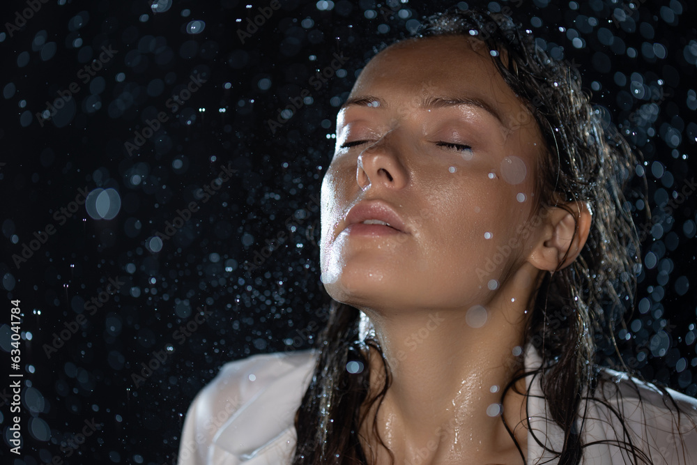 Poster young woman in the rain, getting wet through, wet clothes and ...