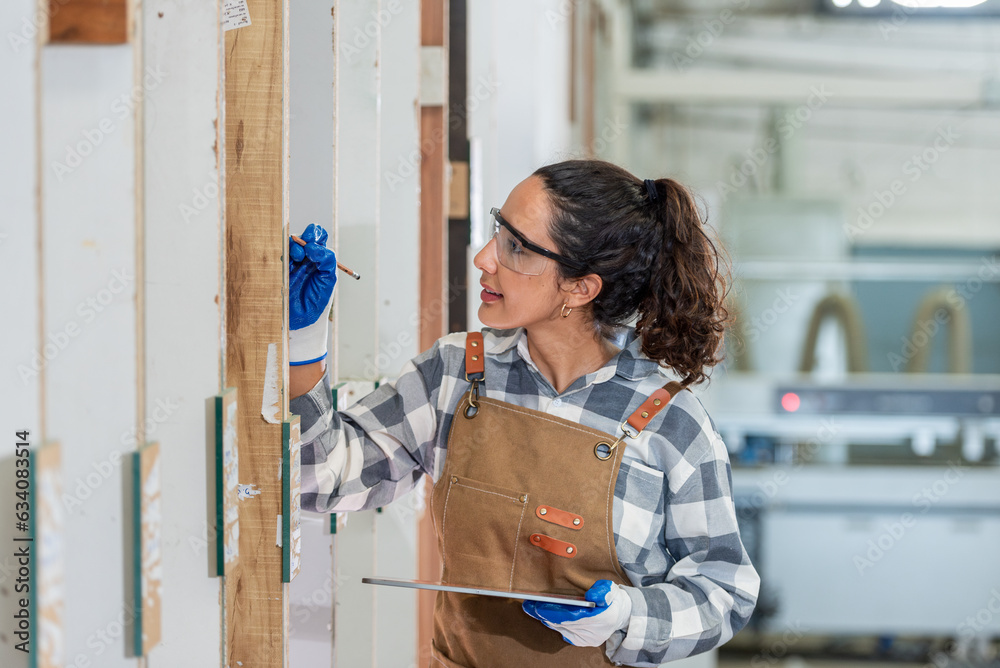 One Strong confident young aged women carpenter standing aim at wood ...