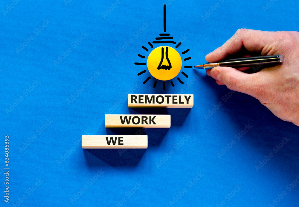 We work remotely symbol. Concept words We work remotely on wooden block ...