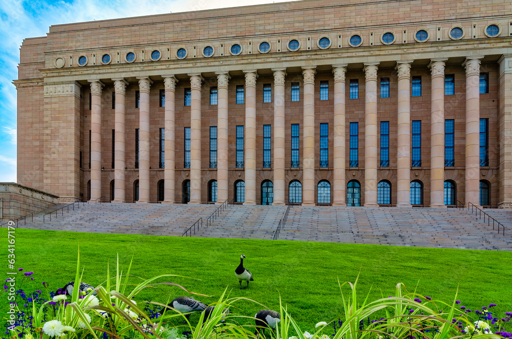 Parliament house of Finland in Helsinki. Geese in front of the building ...
