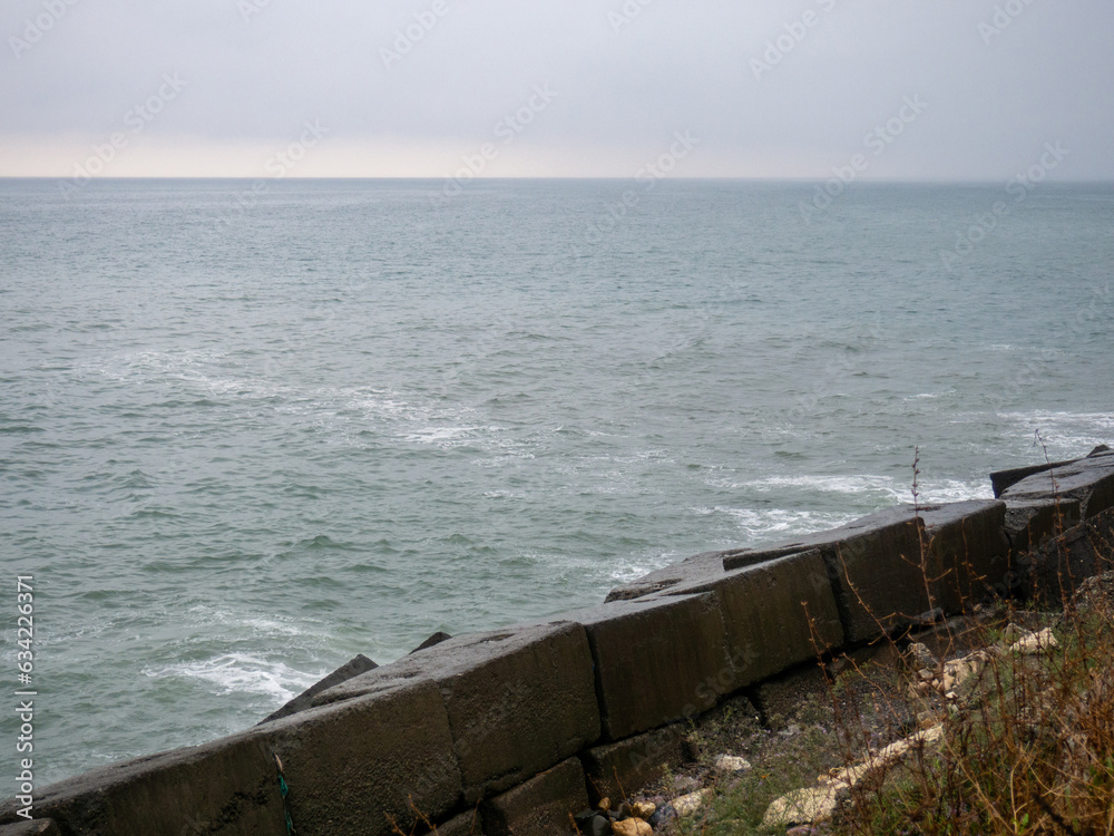 Old blocks of fortifications of the coast. Concrete structures on the ...