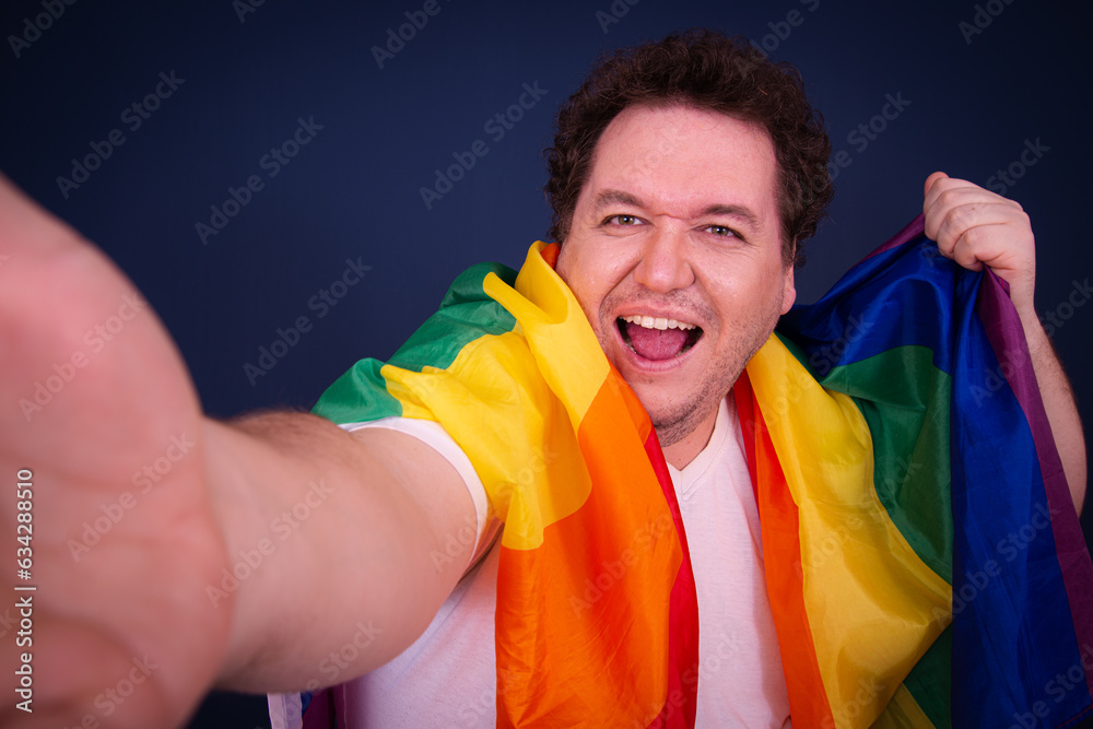 Funny fat man with a rainbow flag posing in the studio. Fight for your ...