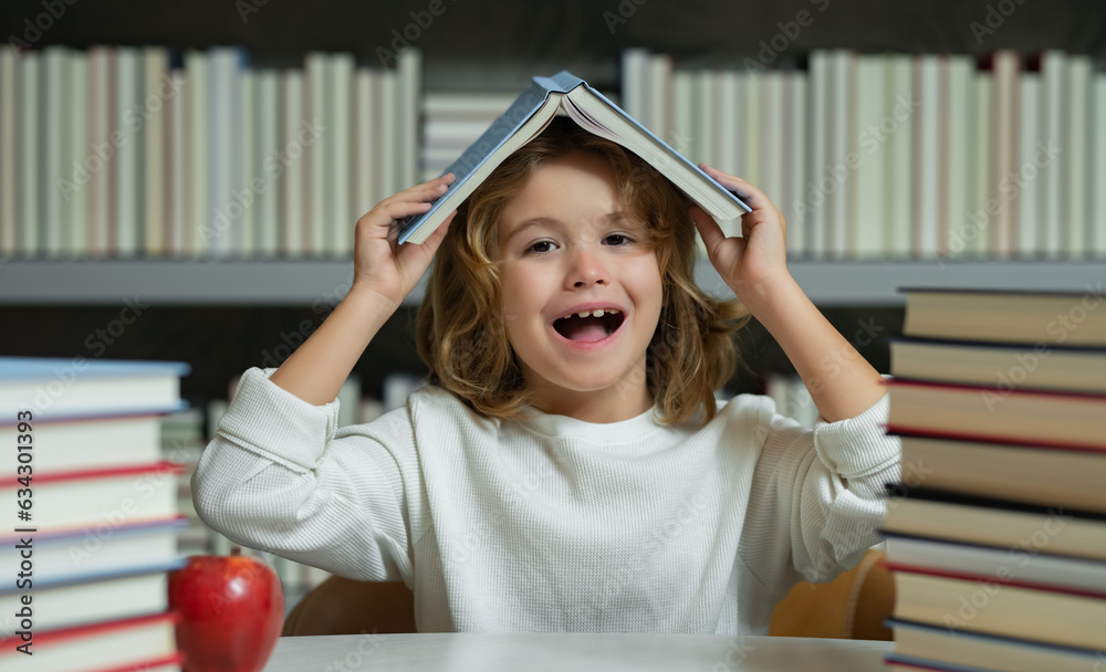 Knowledge day. Kid on school library. Child reading book at school ...