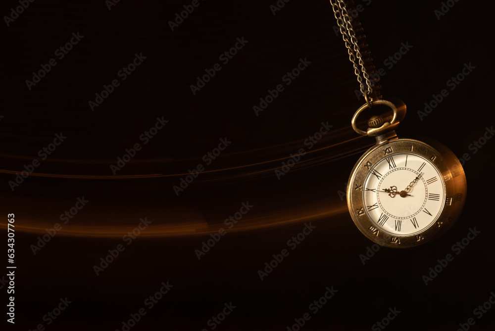 Hypnosis session. Vintage pocket watch with chain swinging over surface ...