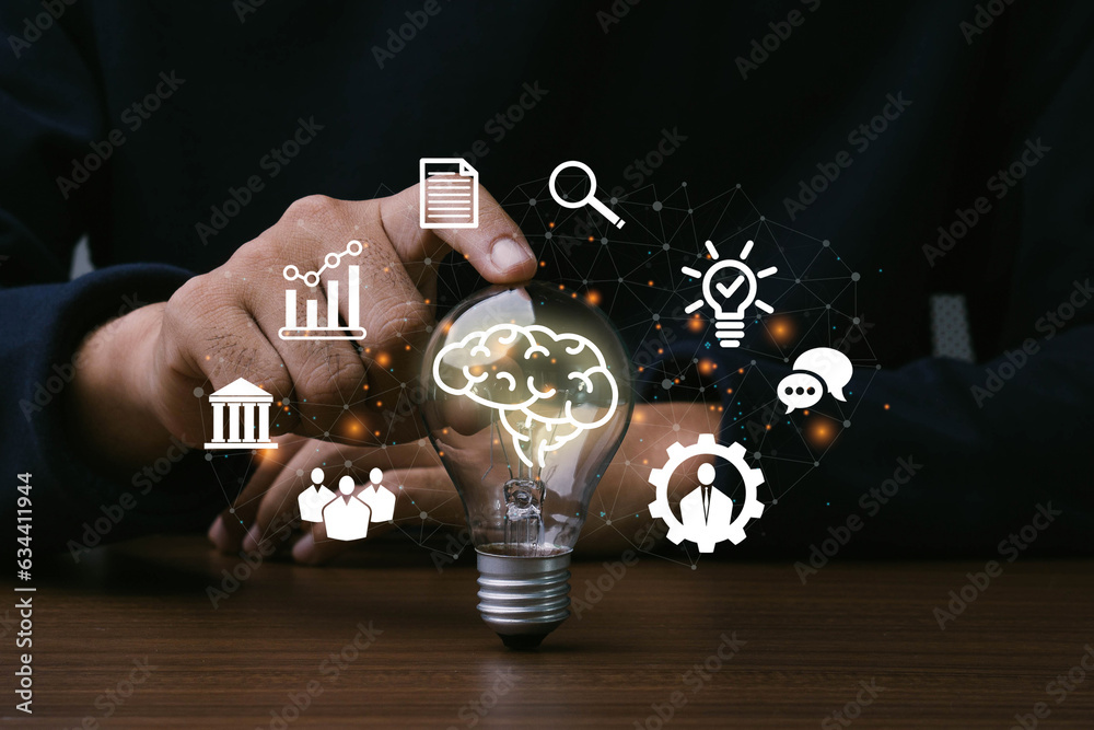 Skills,Knowledge and Ability.Man hand touching light bulb with icon of ...