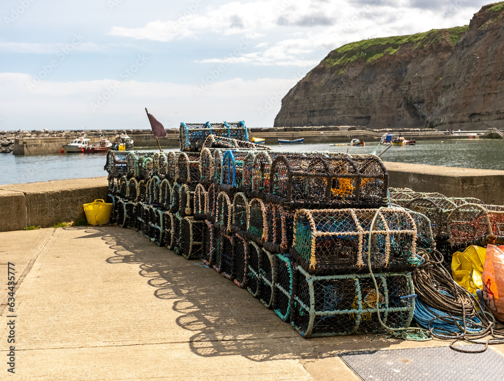 Crab pots lobster pots and fish traps on the quayside in the fishing ...