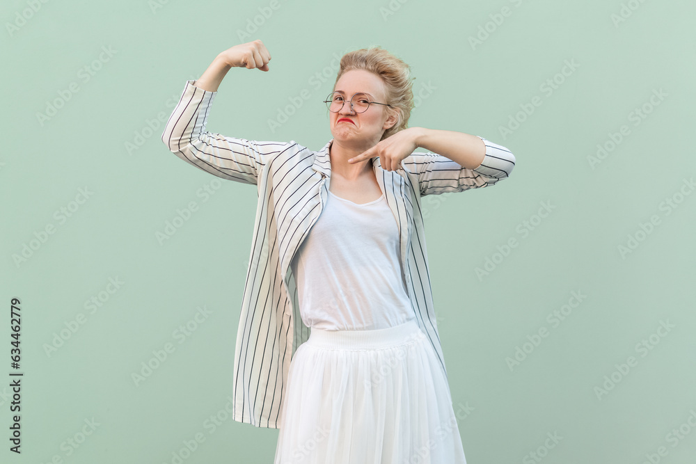 Portrait of strong powerful attractive blonde woman wearing striped ...