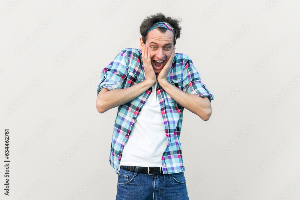 Wow, that great. Overjoyed handsome man keeps hands on cheeks, looks ...