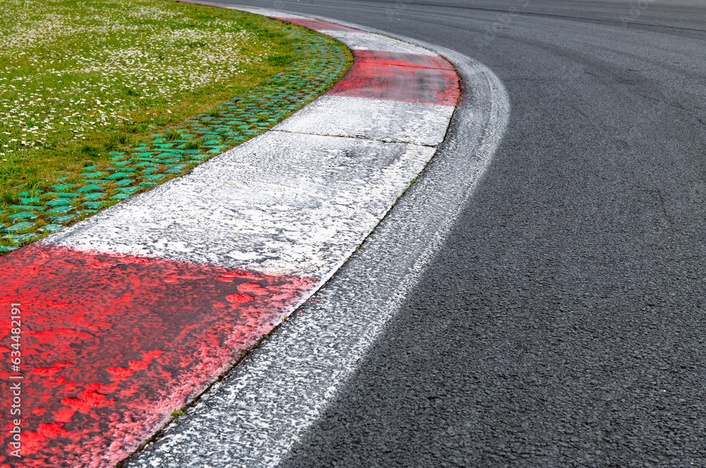 Motor sport asphalt race track and curbs with skid marks, low angle ...