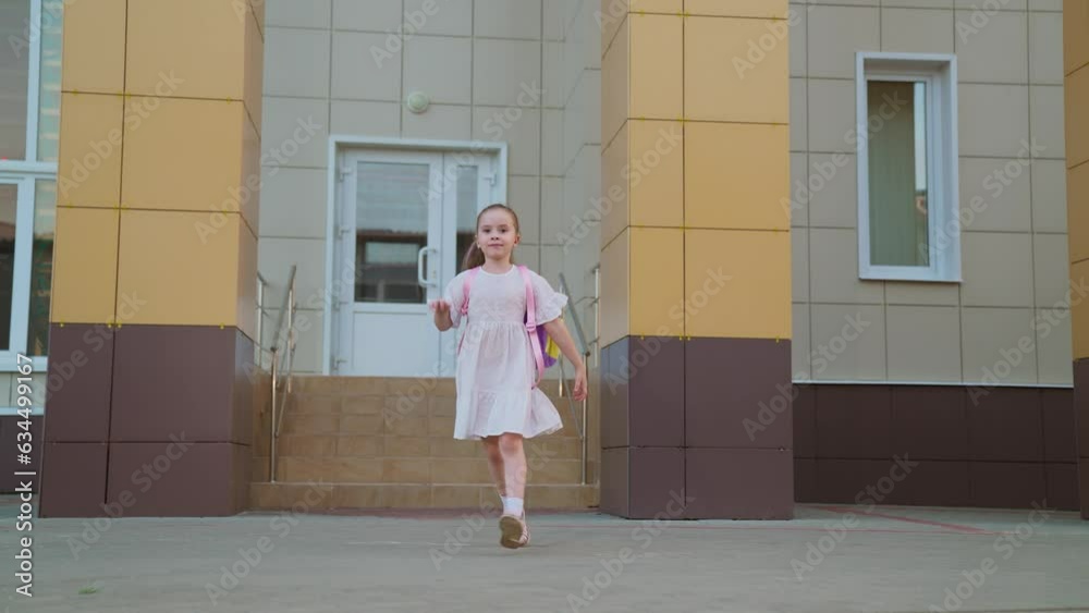 little girl with school backpack runs happy school. children leg ...