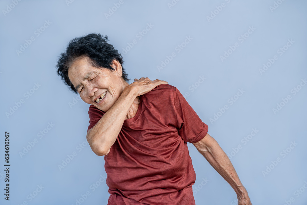 Senior woman hands touching neck and shoulders showing suffering from ...