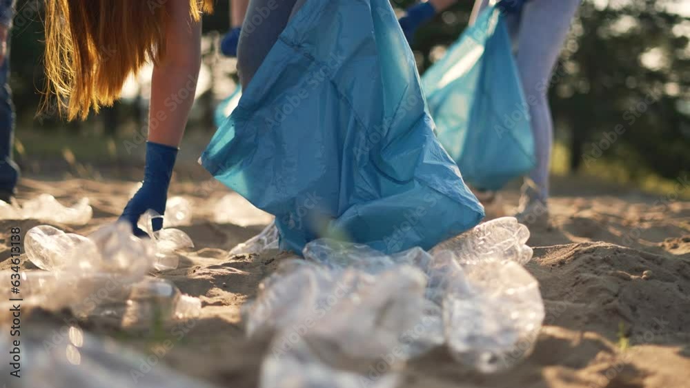 Teamwork.Cleaning plastic garbage in bag on beach in summer ...