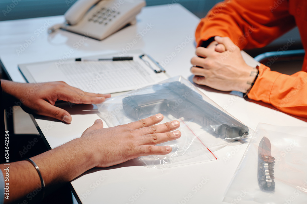 Detective showing criminal gun as incriminating evidence when they are ...