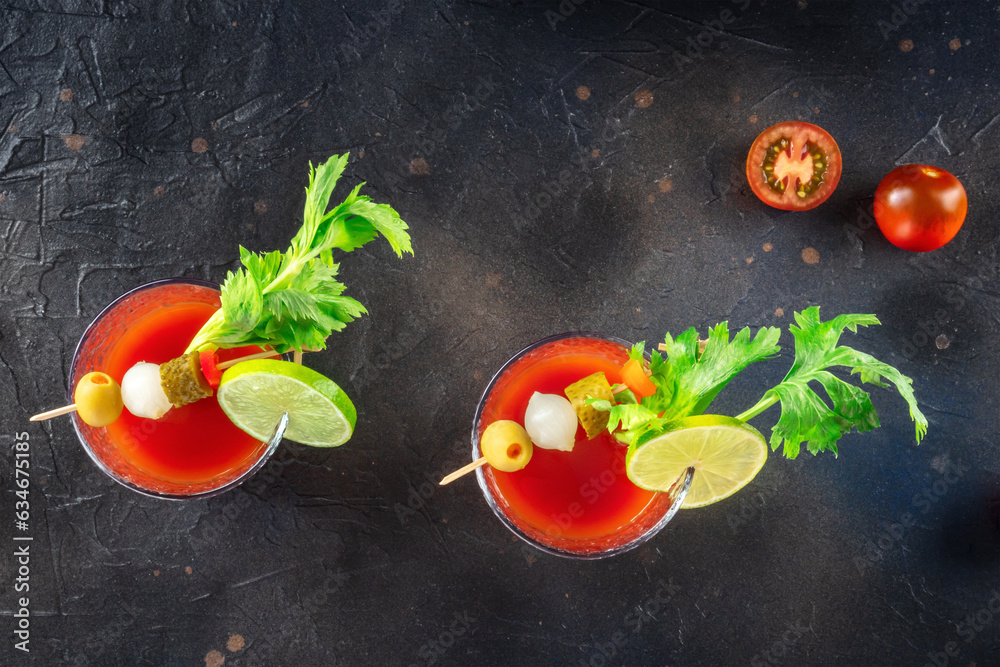 Bloody Mary cocktail with garnish on a black background, top shot with ...