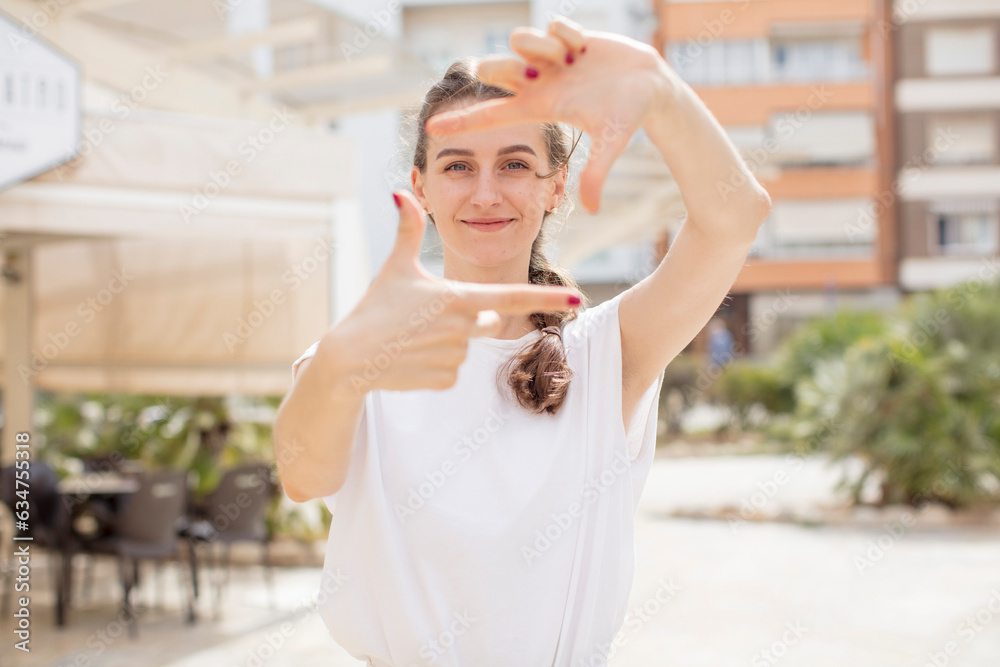 pretty woman feeling happy, friendly and positive, smiling and making a ...