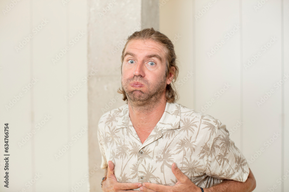 young blond adult man with a goofy, crazy, surprised expression ...