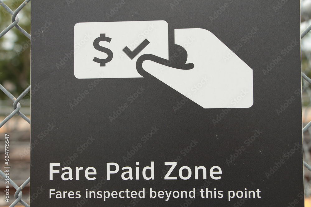 fare paid zone fares inpected beyond this point caption sign in white ...