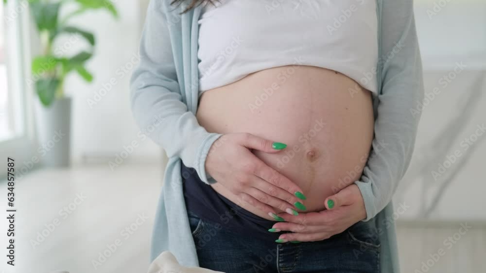 4k Pregnant expectant mother caressing her belly. Woman hands touching ...