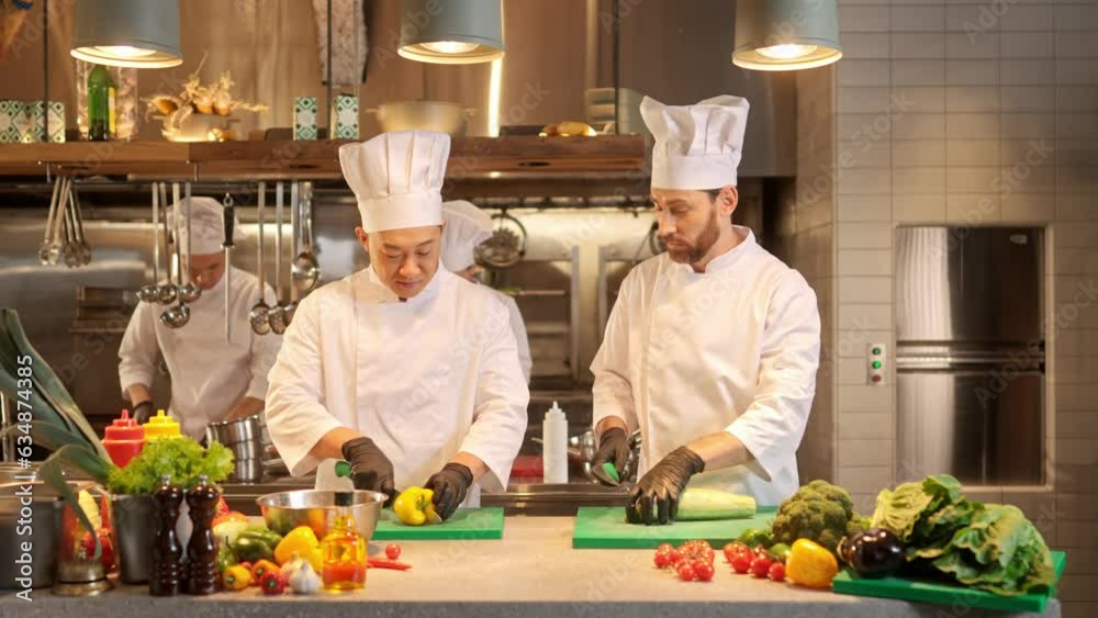 Two multicultural chefs communicate at workplace on background of ...