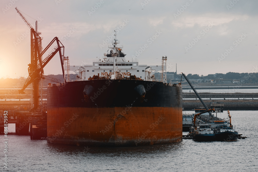 Very large crude oil carrier during loading and bunkering operations in ...