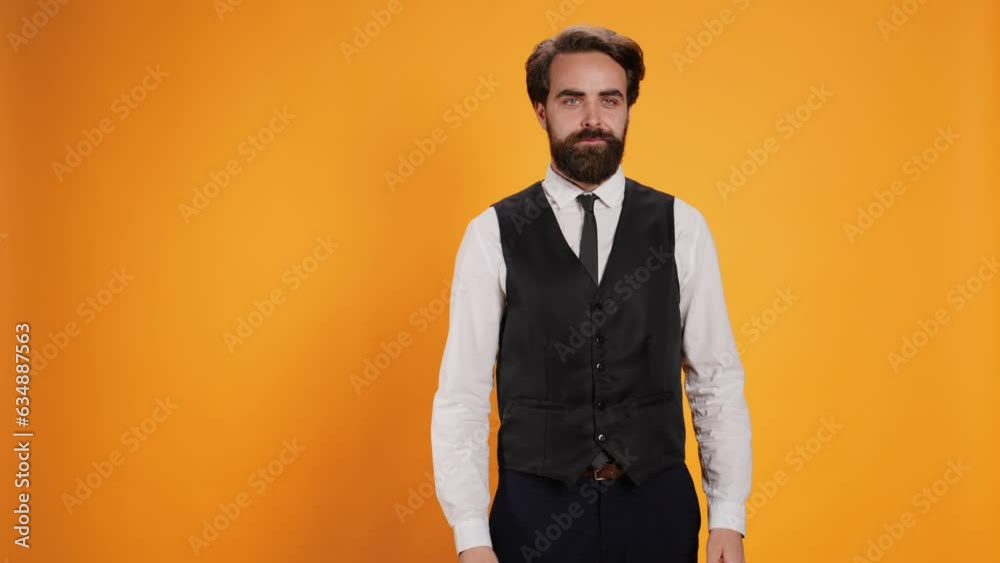 Satisfied waiter does positive gesture while showing his appreciation ...